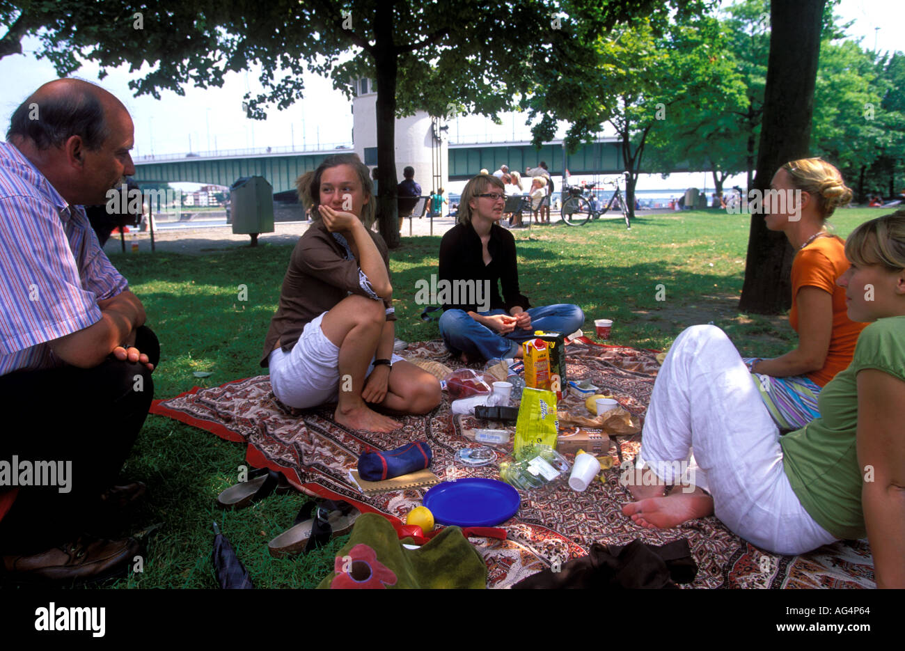 Germany North Rhine Westphalia Cologne People having a picnic in a park ...