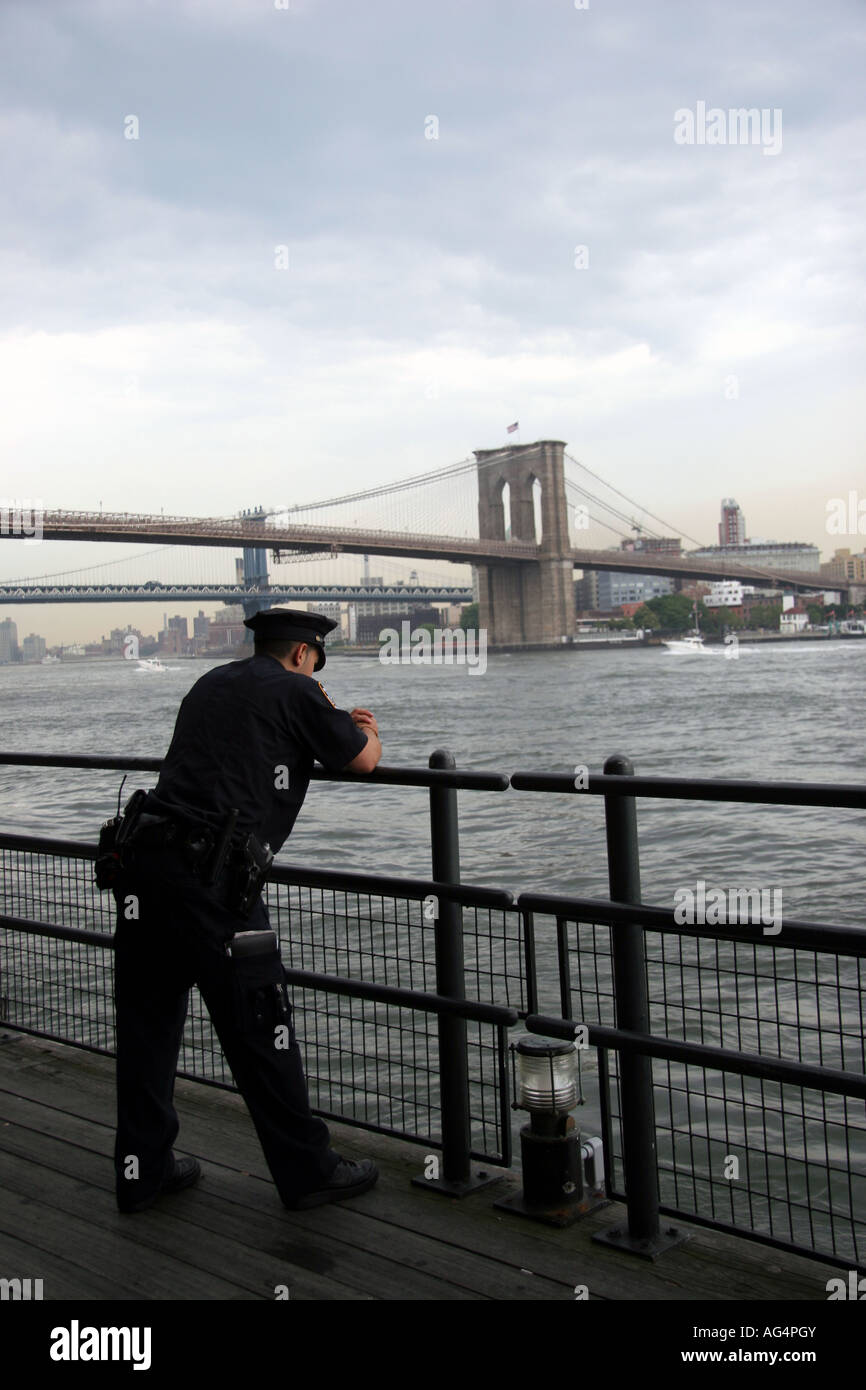 NYPD officer overlooking Brooklyn Bridge Stock Photo - Alamy