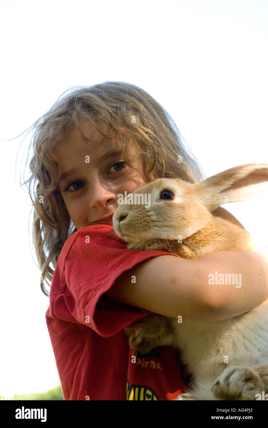 Five year old girl with pet rabbit Thumper Georgia Starkey model ...