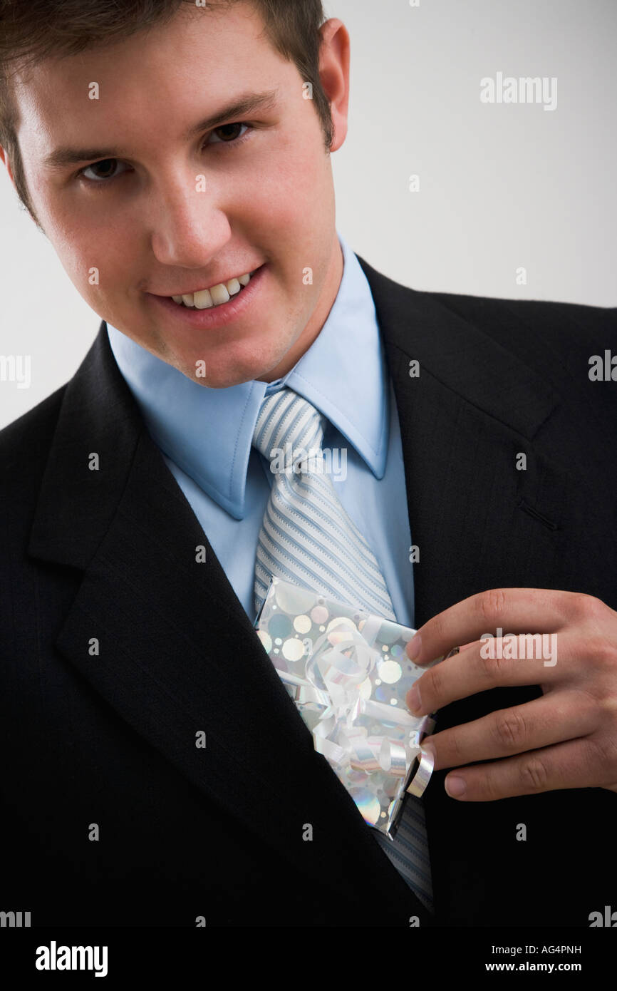 Man hiding gift in his suit Stock Photo - Alamy