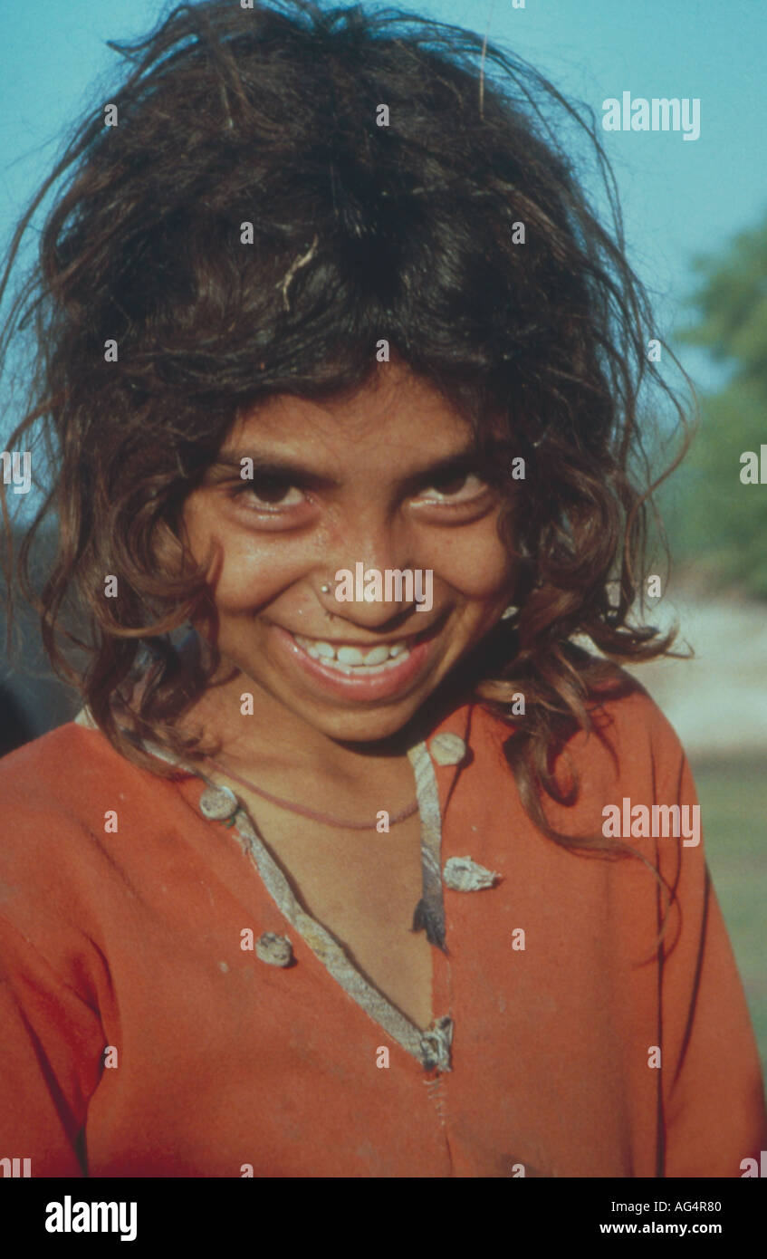 Young Pashtun girl wearing red top with straw in hair Peshawar Pakistan ...