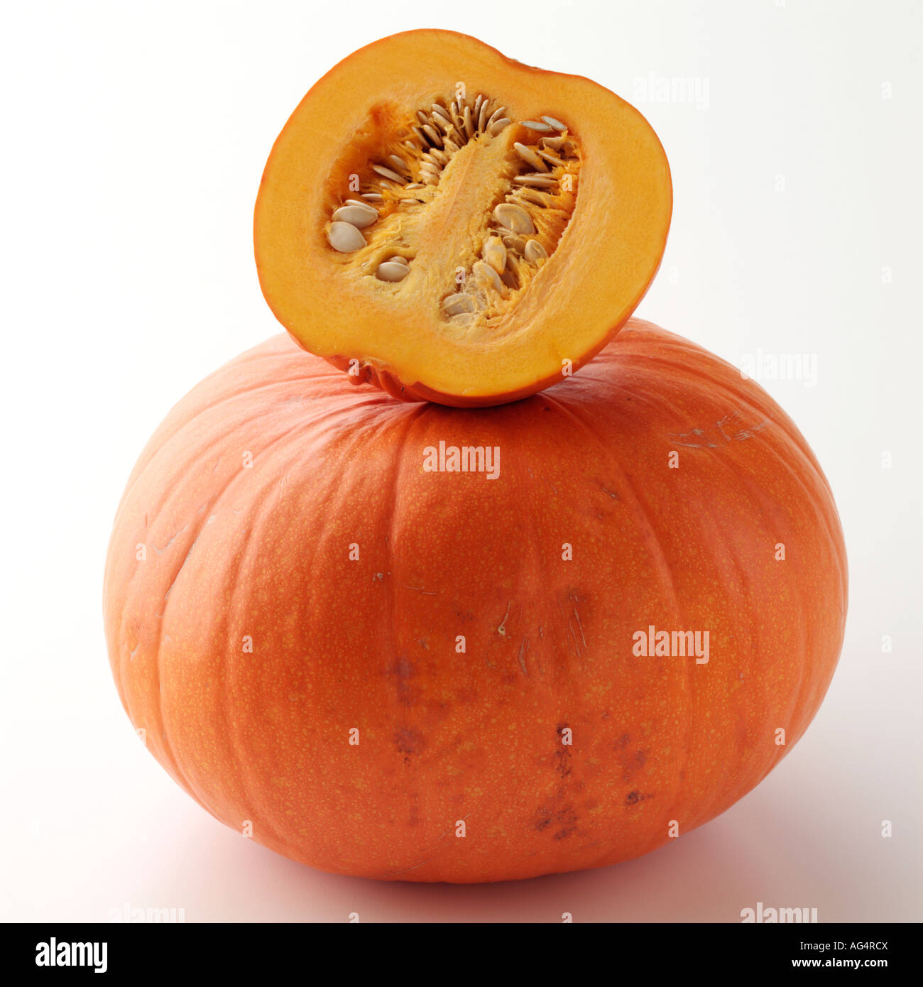 A half pumpkin on top of a whole pumpkin on a white background Stock ...
