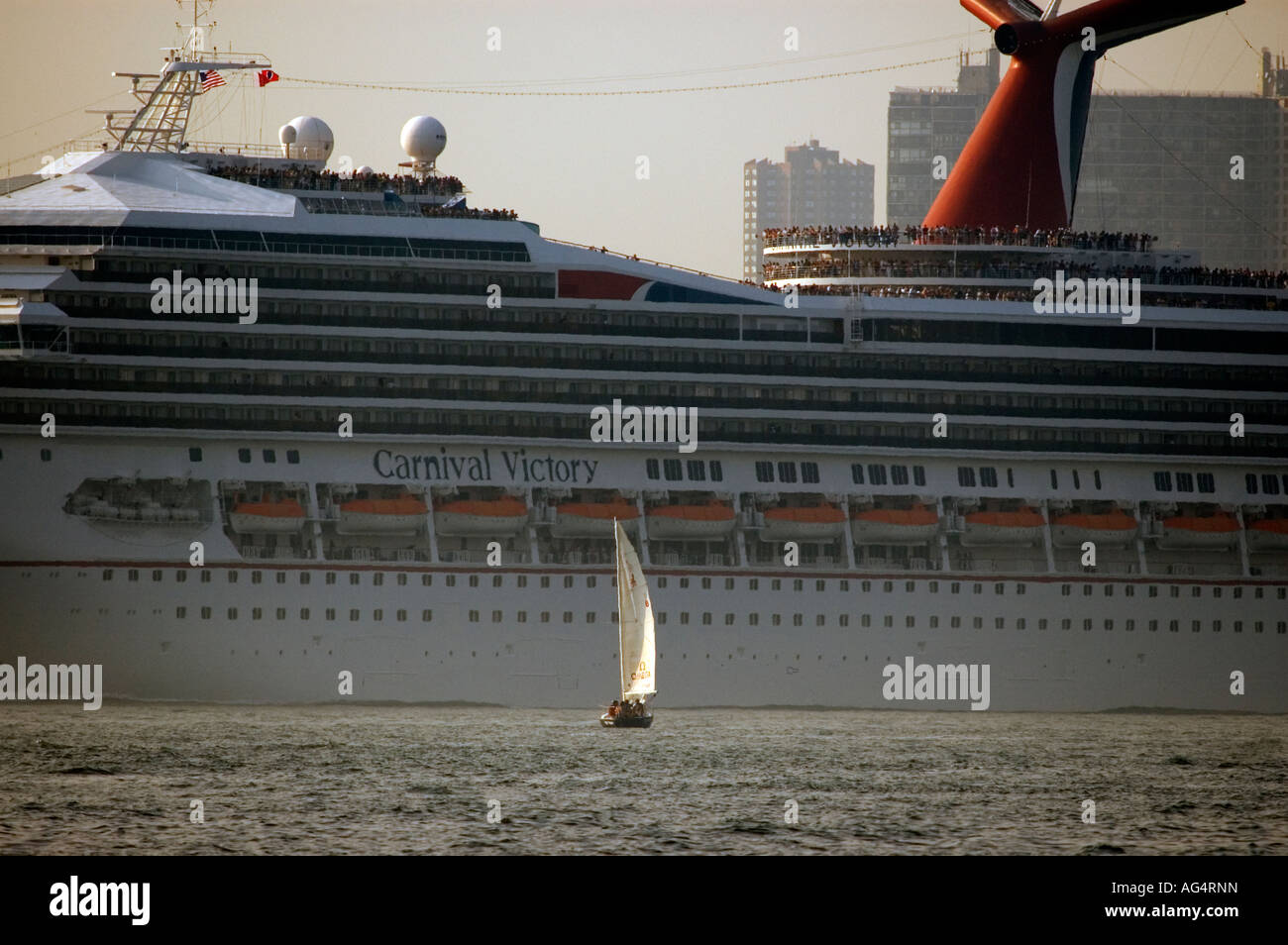 The Carnival Victory cruise ship passes a sailboat on it s way out of ...