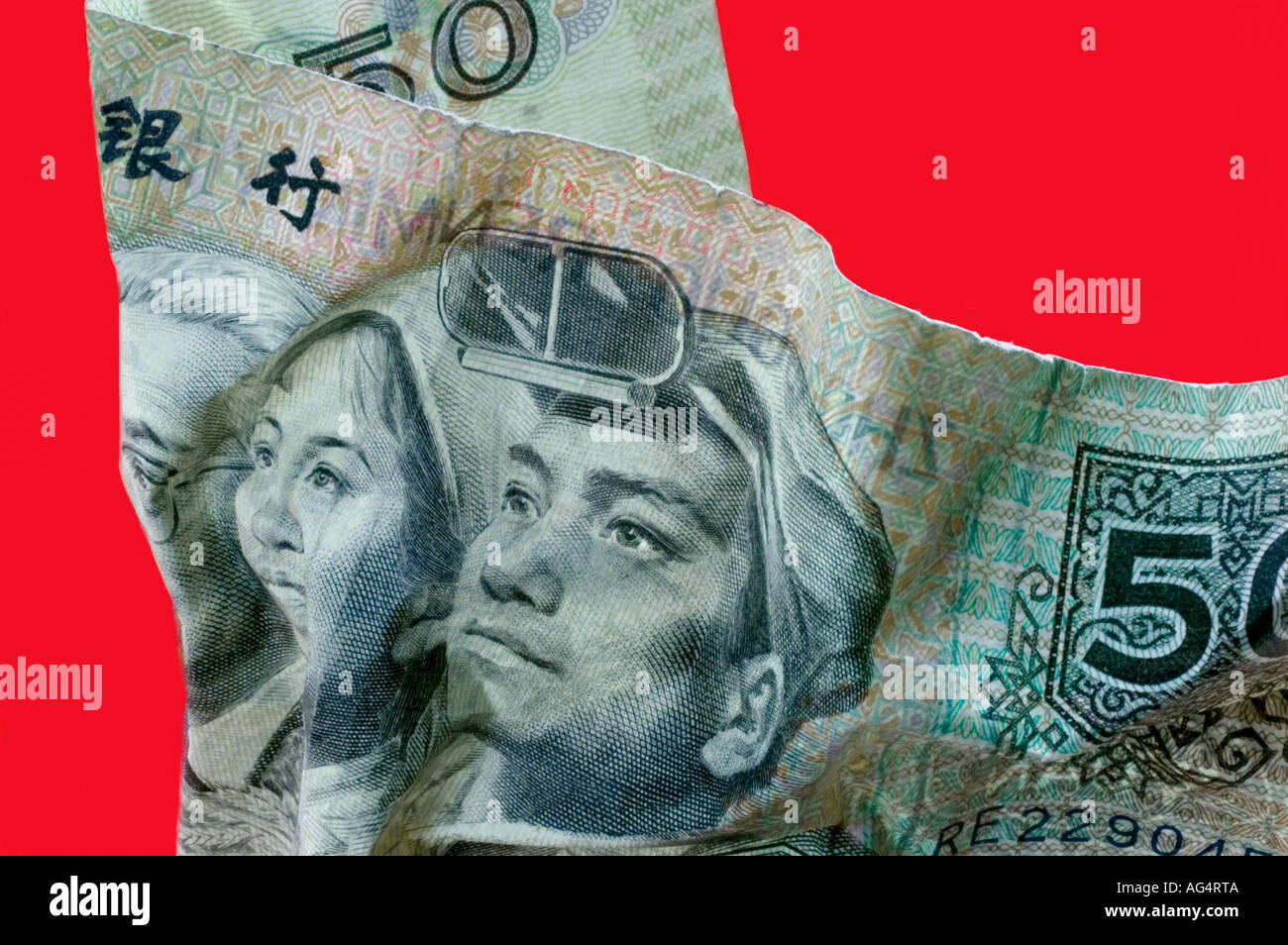 Chinese Yuan on red background Stock Photo - Alamy