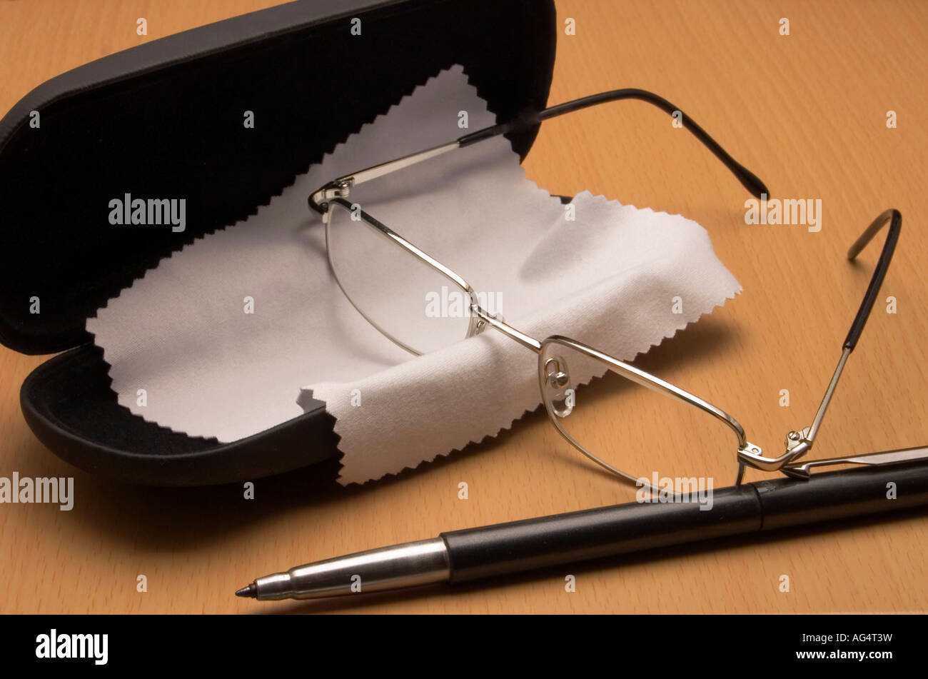 Spectacles with case on a table top Stock Photo - Alamy