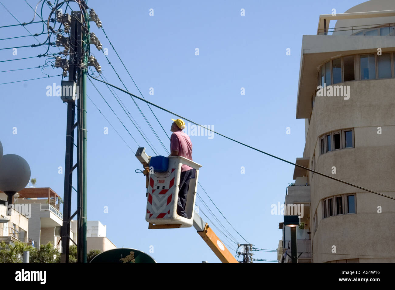 A hoisted technician fixing electric power wires Stock Photo - Alamy