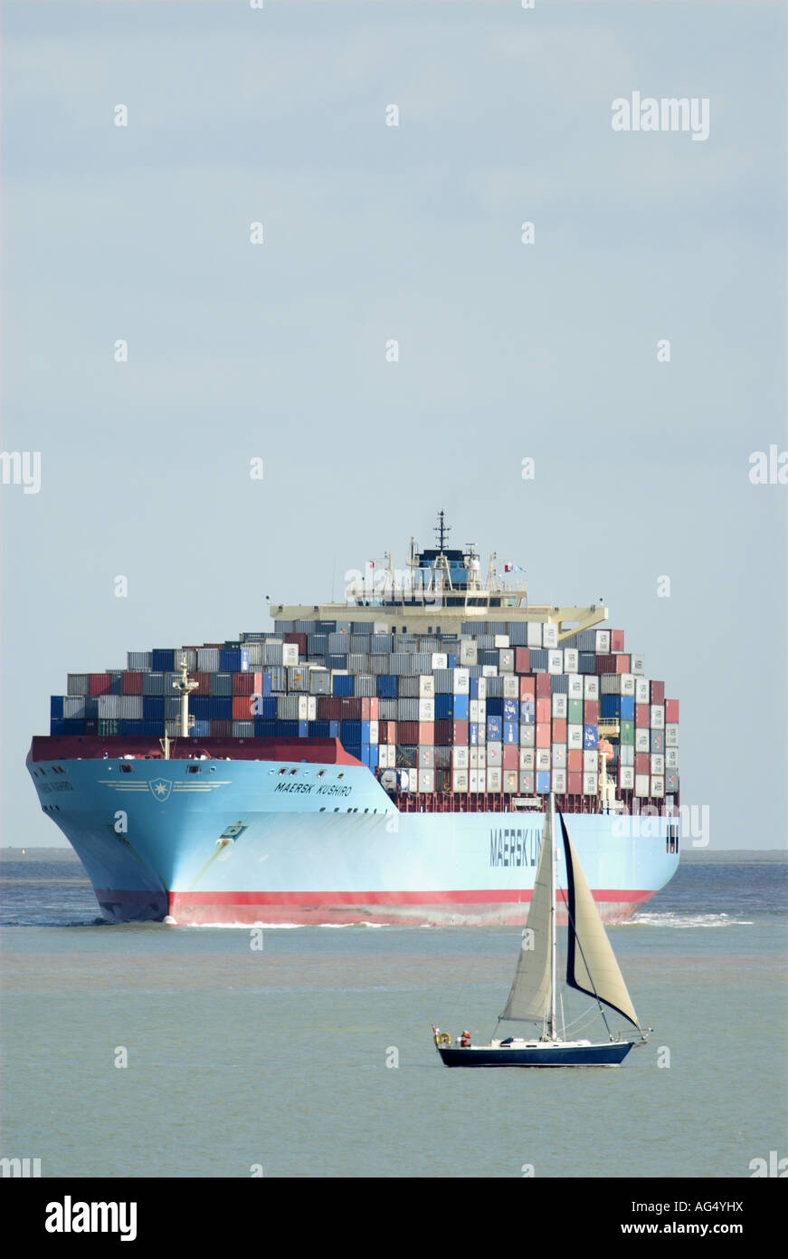 Container ship approaching felixstowe docks with small sailing craft in ...