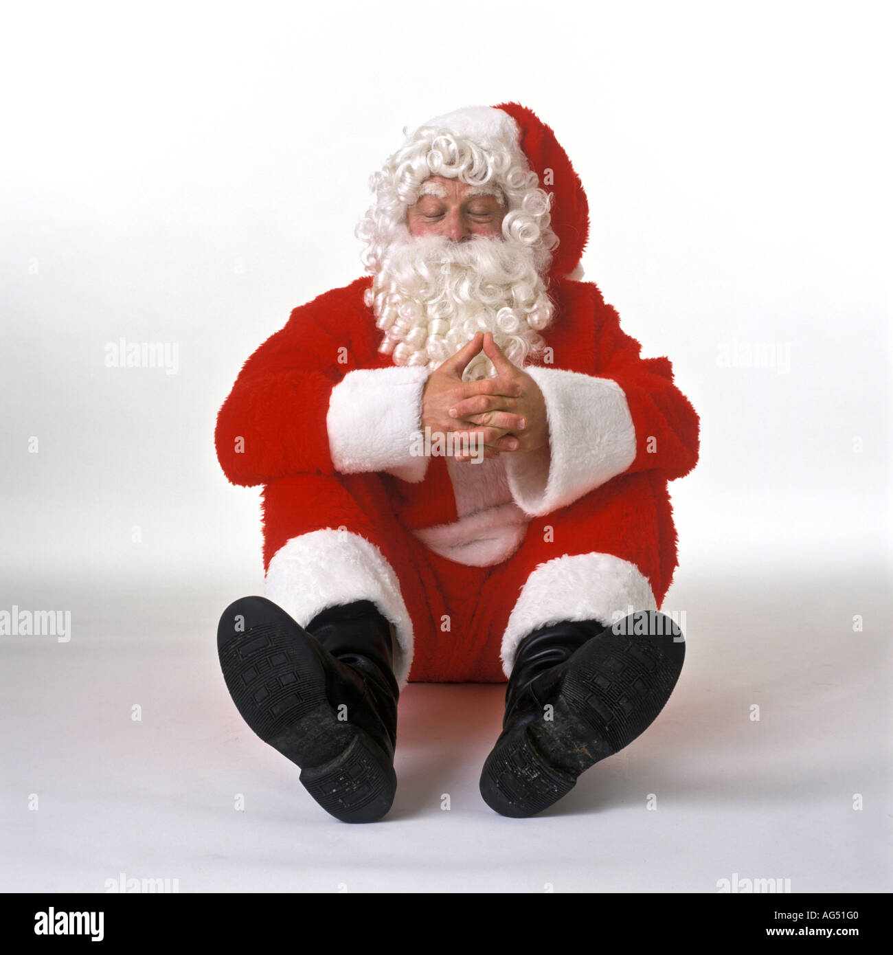 Santa Claus in meditation on white background Stock Photo - Alamy