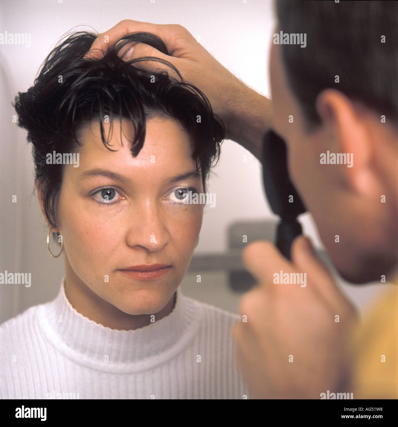 Doctor is checking the eye pressure of a female patient Stock Photo - Alamy