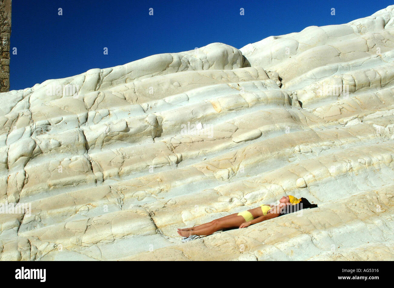 girl lie in the sun on a calcareous rock formation scala dei turchi ...