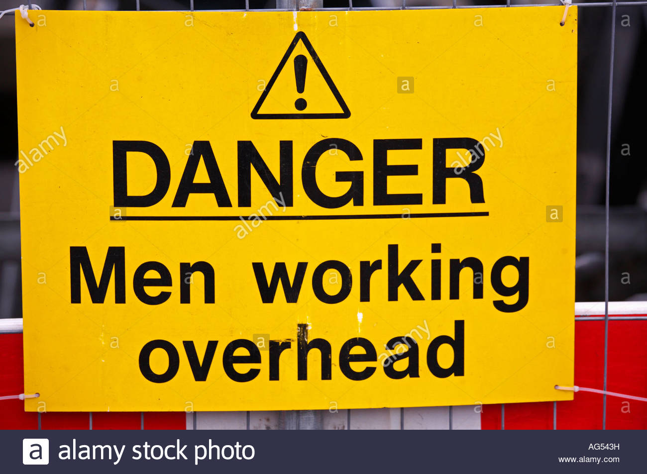 Danger men working overhead signpost Stock Photo - Alamy