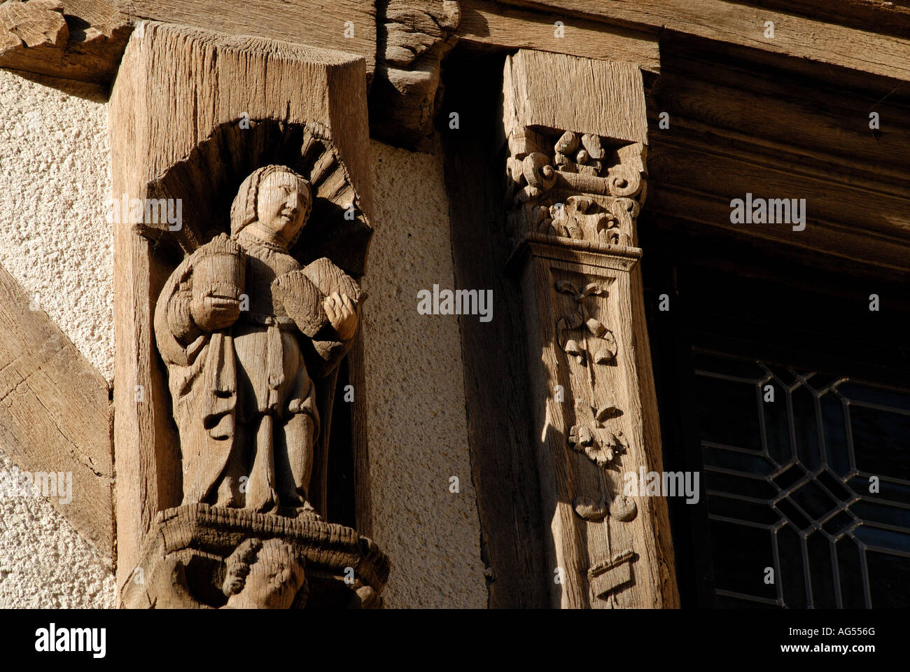 Medieval rustic wood carving on facade of half-timbered house in French ...