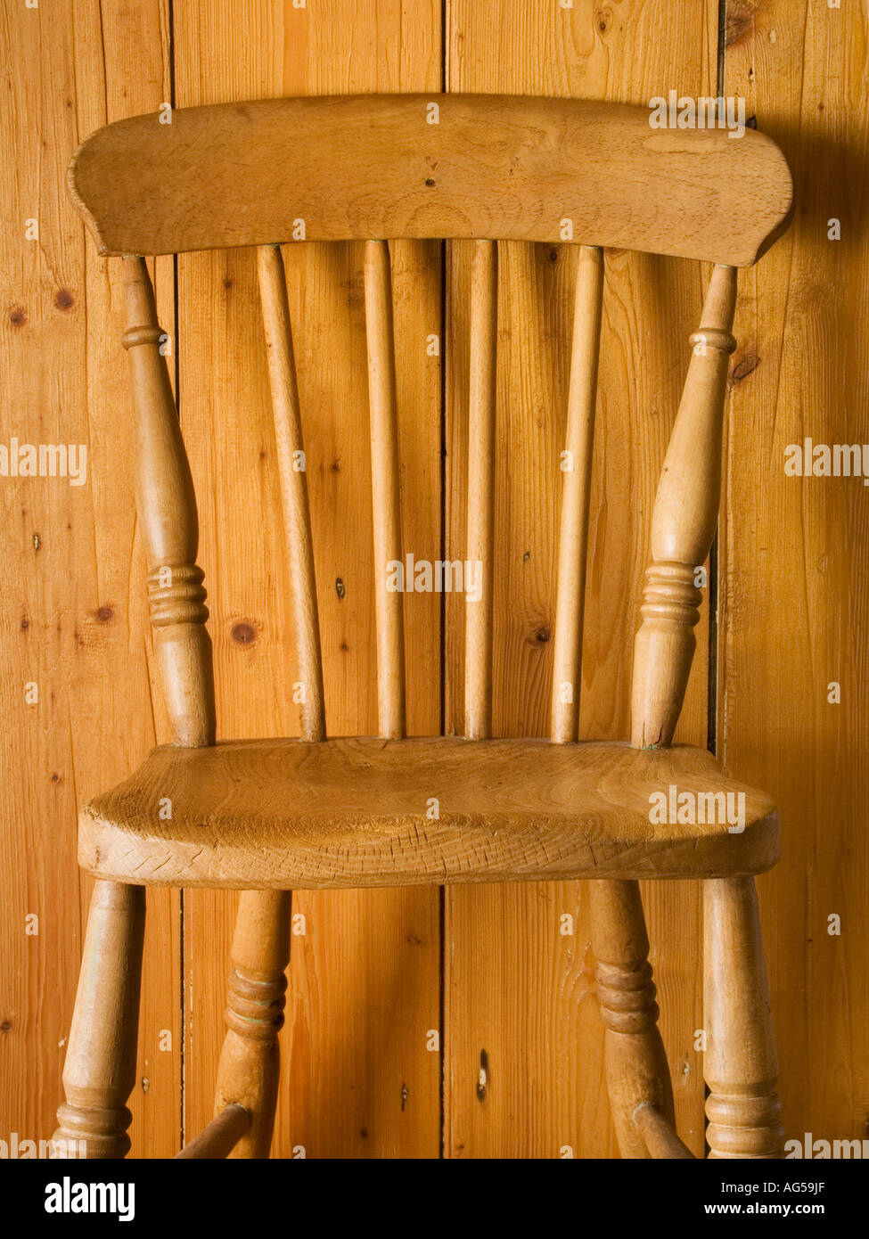 wooden chair against panelled wall Stock Photo - Alamy