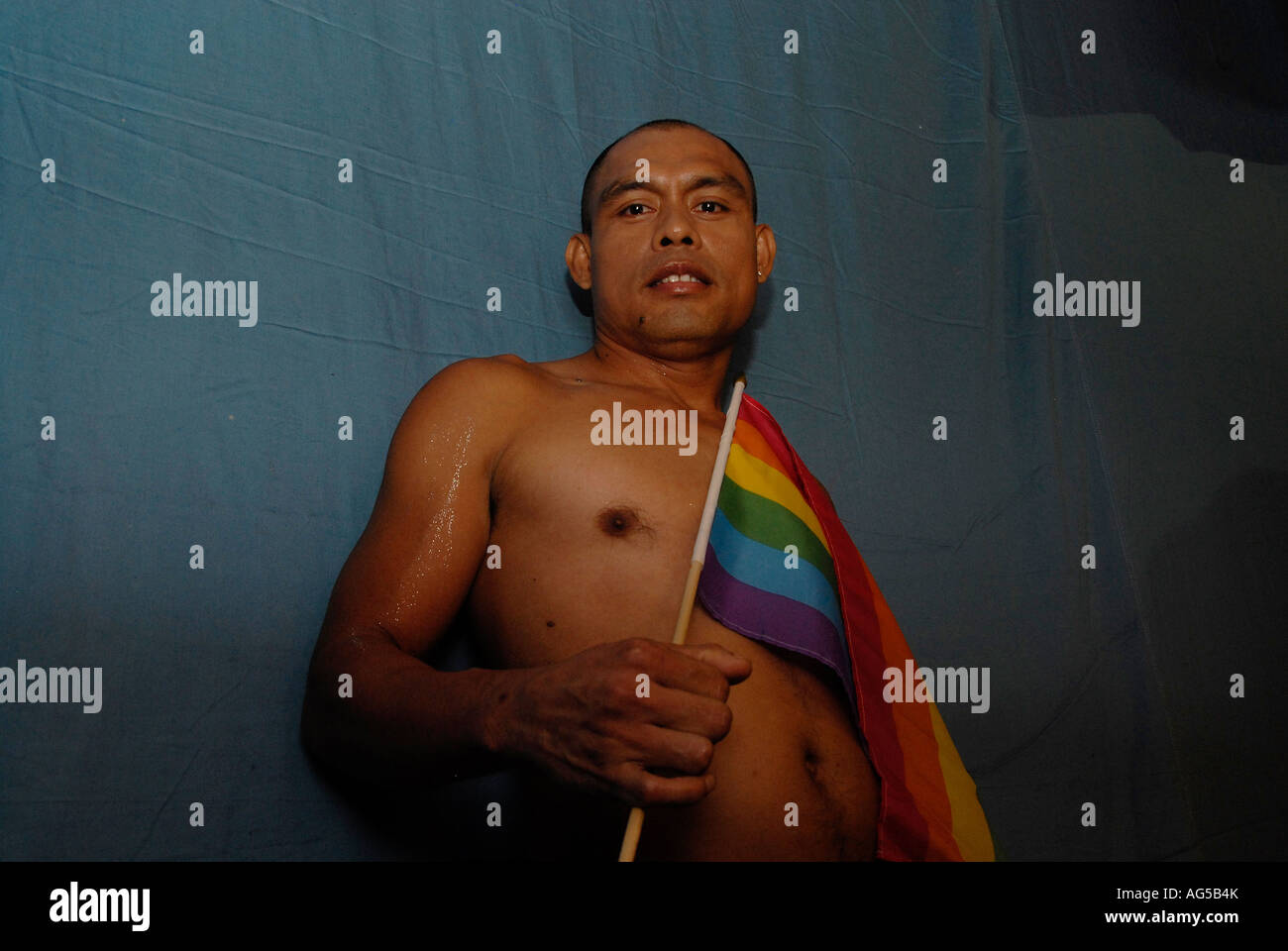 A Filipino transgender holds the LGBT, or GLBT flag during a beauty ...
