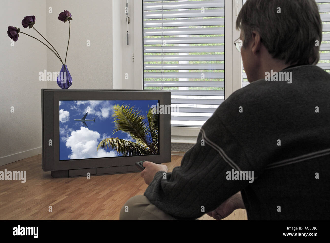 man watching TV (picture on TV is mine Stock Photo - Alamy