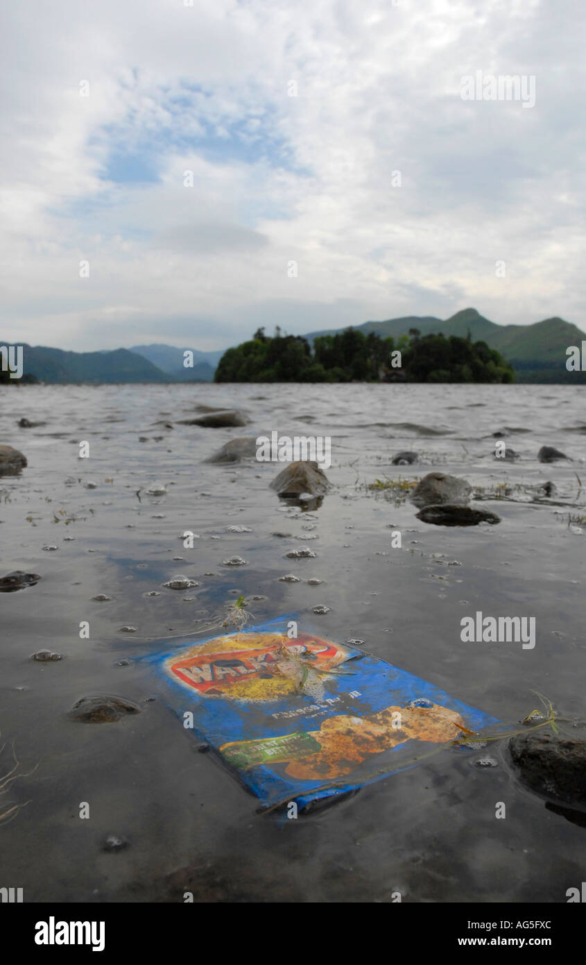 Discarded Walkers crisp packet floating on Derwentwater Lake Keswick ...