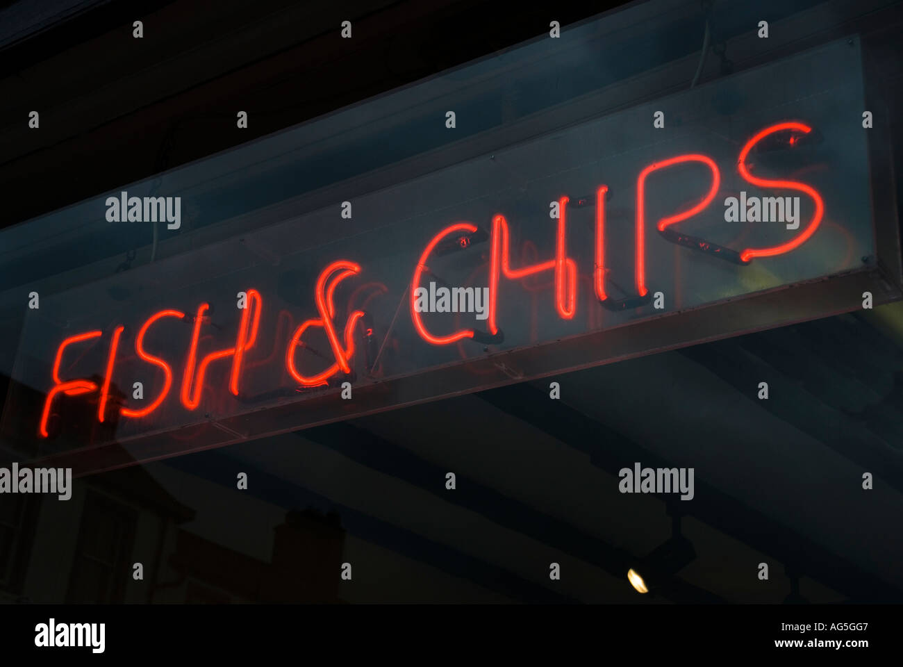 Neon sign in a fish and chip shop Stock Photo - Alamy