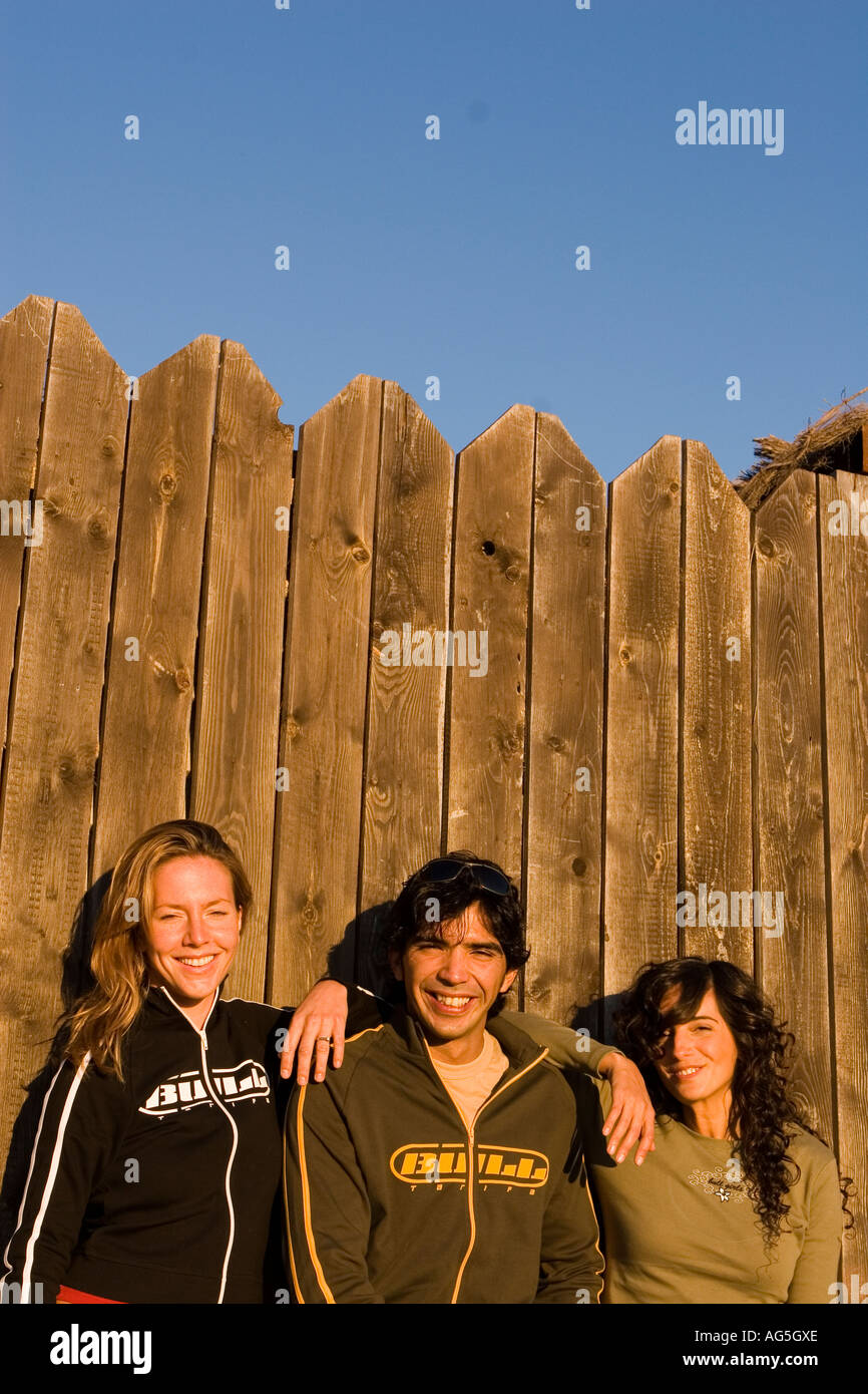 Friends chating and having fun with wood fence background Stock Photo ...