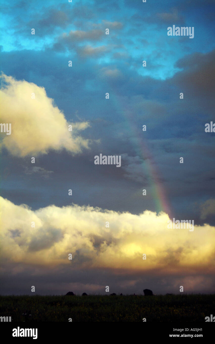 Dramatic clouds and faint rainbow hi-res stock photography and images ...