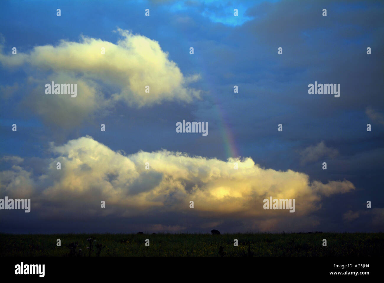 Dramatic clouds and faint rainbow hi-res stock photography and images ...