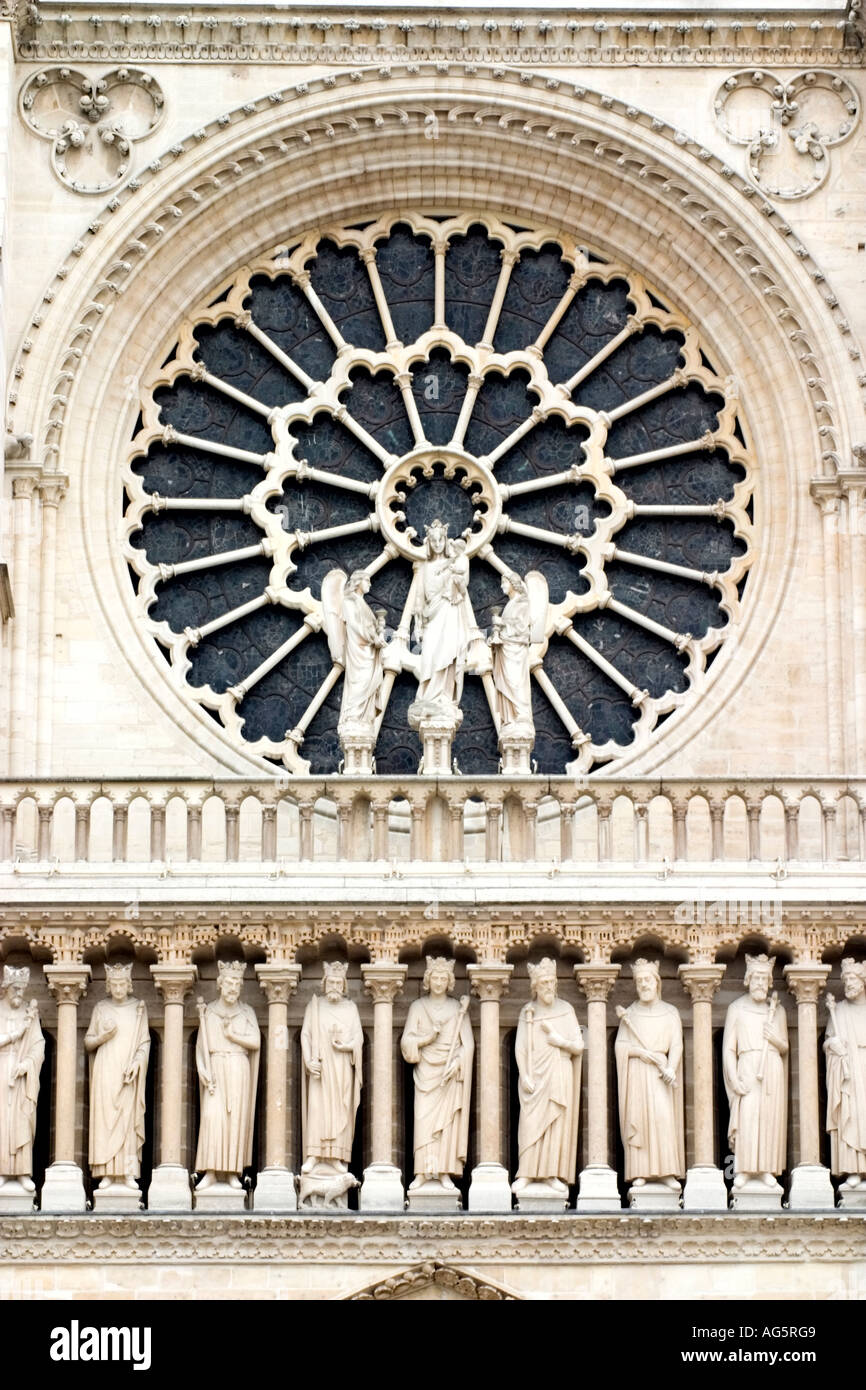 Ornamental carving on Notre Dame against the circular rose window Stock ...