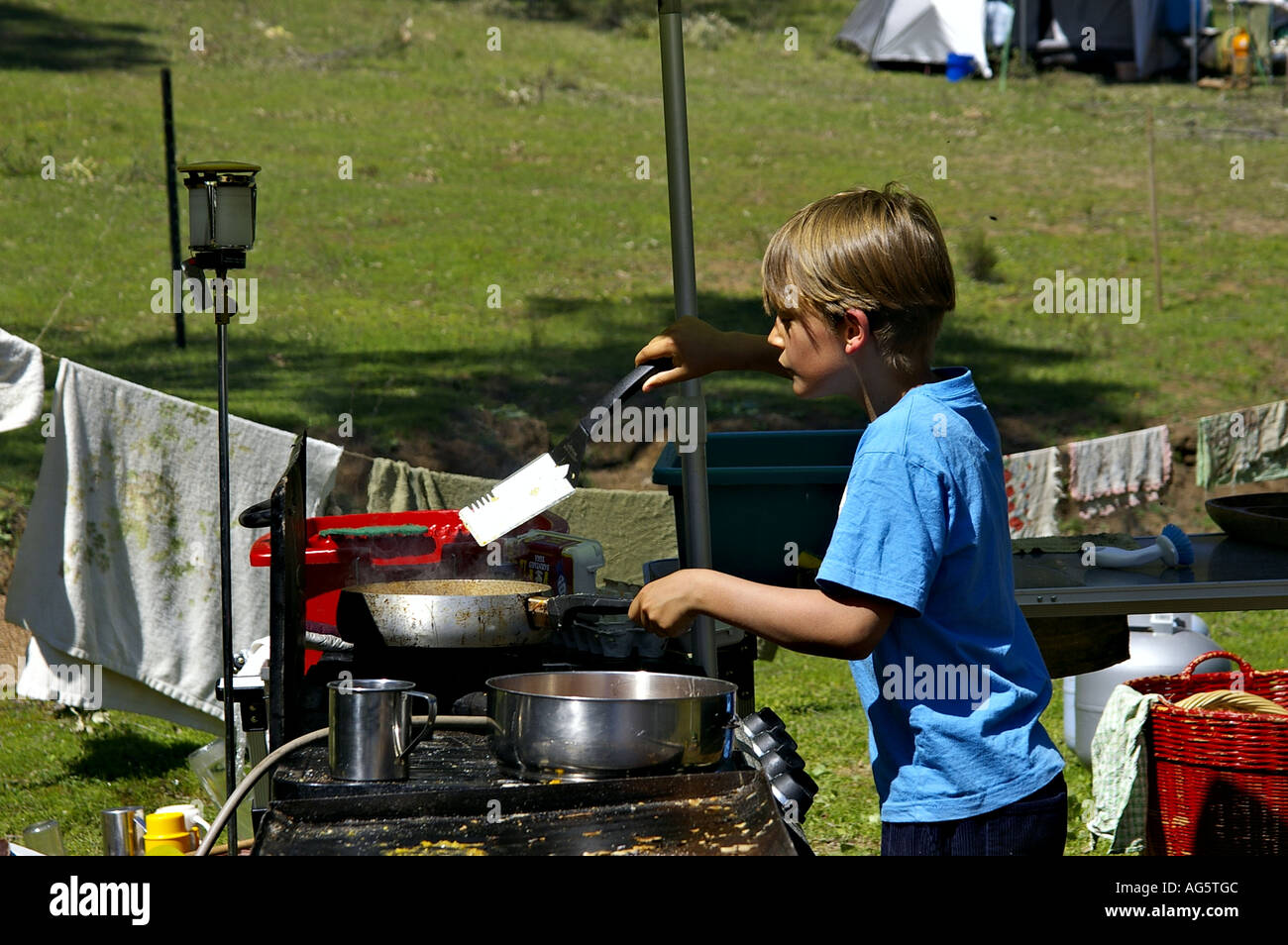 Child cooking eggs camping hi-res stock photography and images - Alamy
