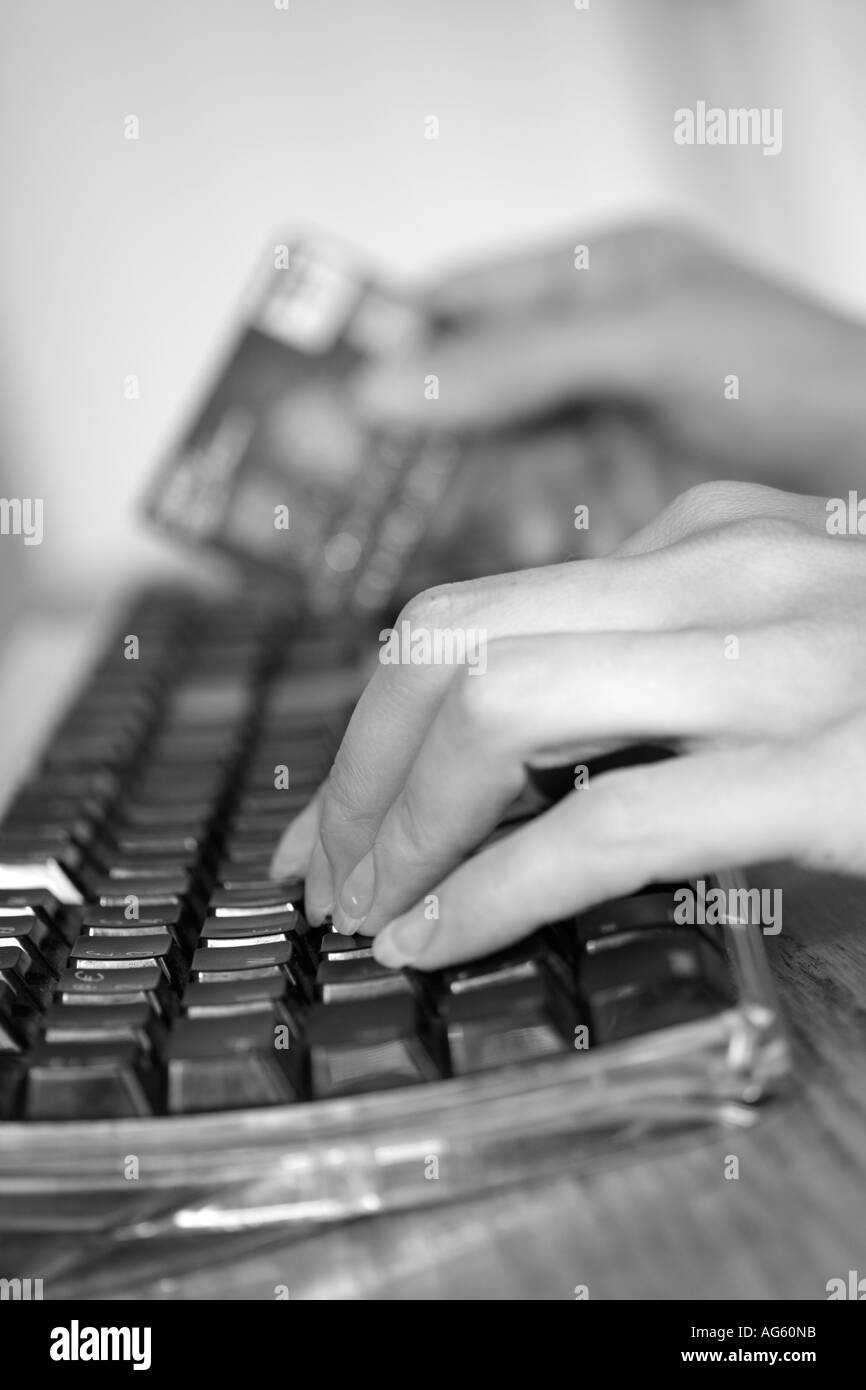 Online shopping - female hand at keyboard with credit card shot in ...