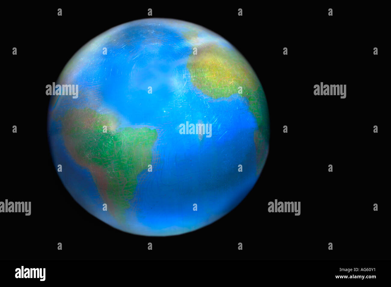 Globe in vivid blue and green against black background Stock Photo - Alamy
