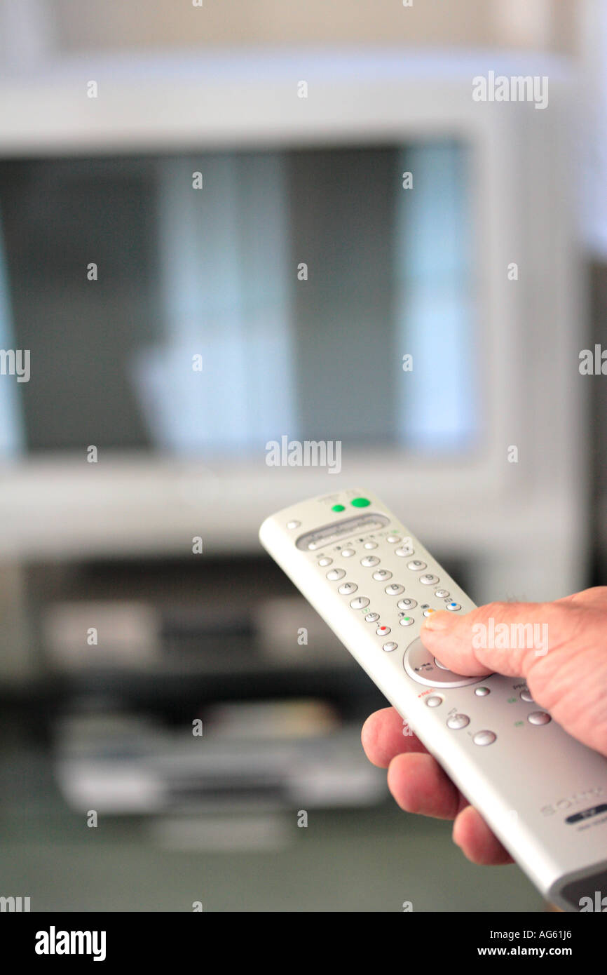 Silver remote control and television Stock Photo - Alamy