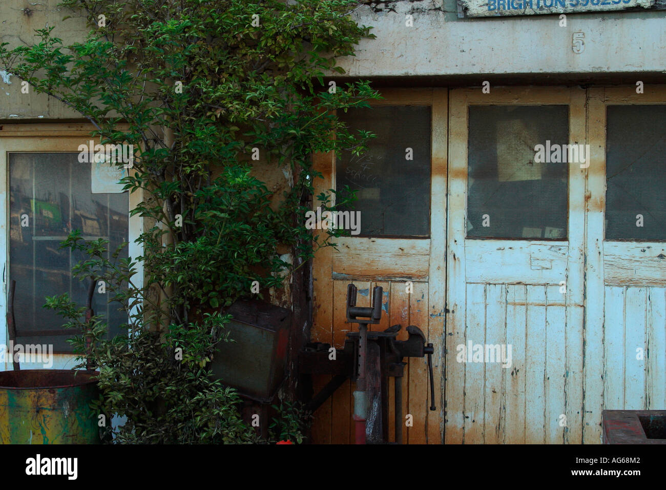 Rundown lockup garage with peeling paint on doors Stock Photo - Alamy