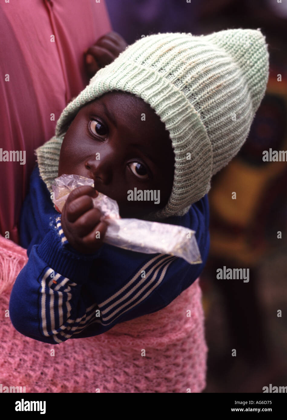 African child being carried on back of mother Stock Photo - Alamy
