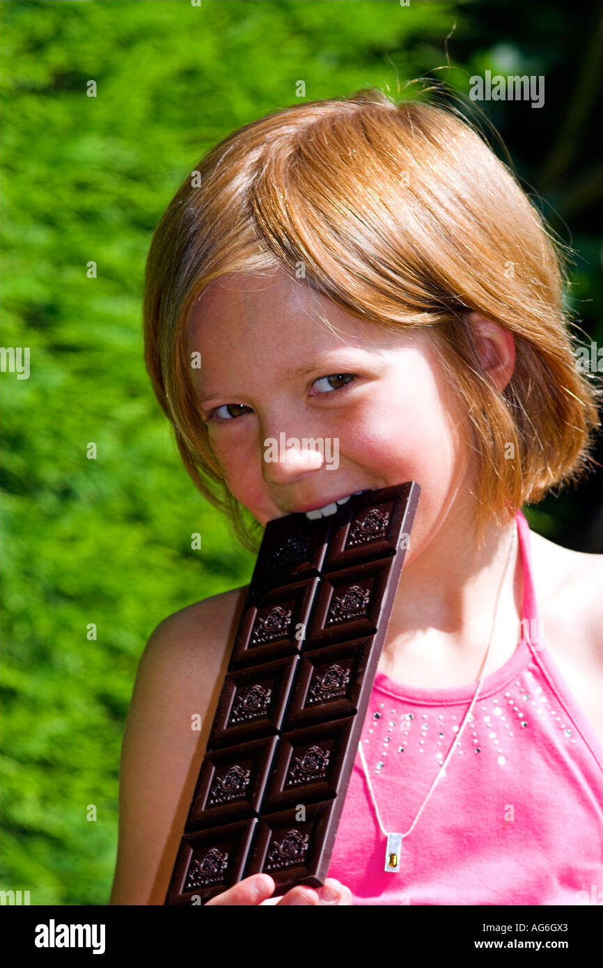 Child eating a large bar of dark chocolate Stock Photo - Alamy
