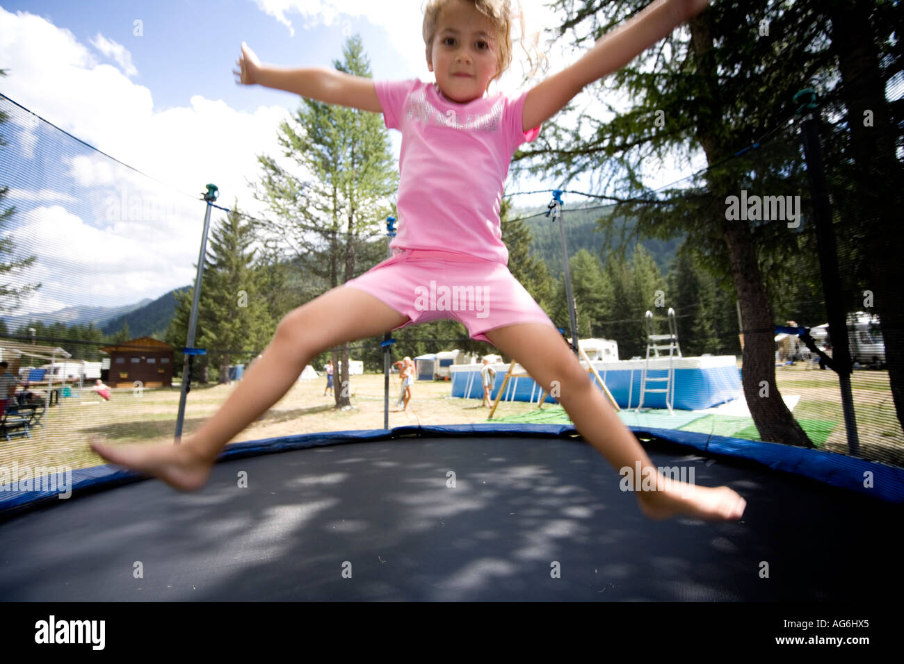 little girl jumping at the playground Stock Photo - Alamy