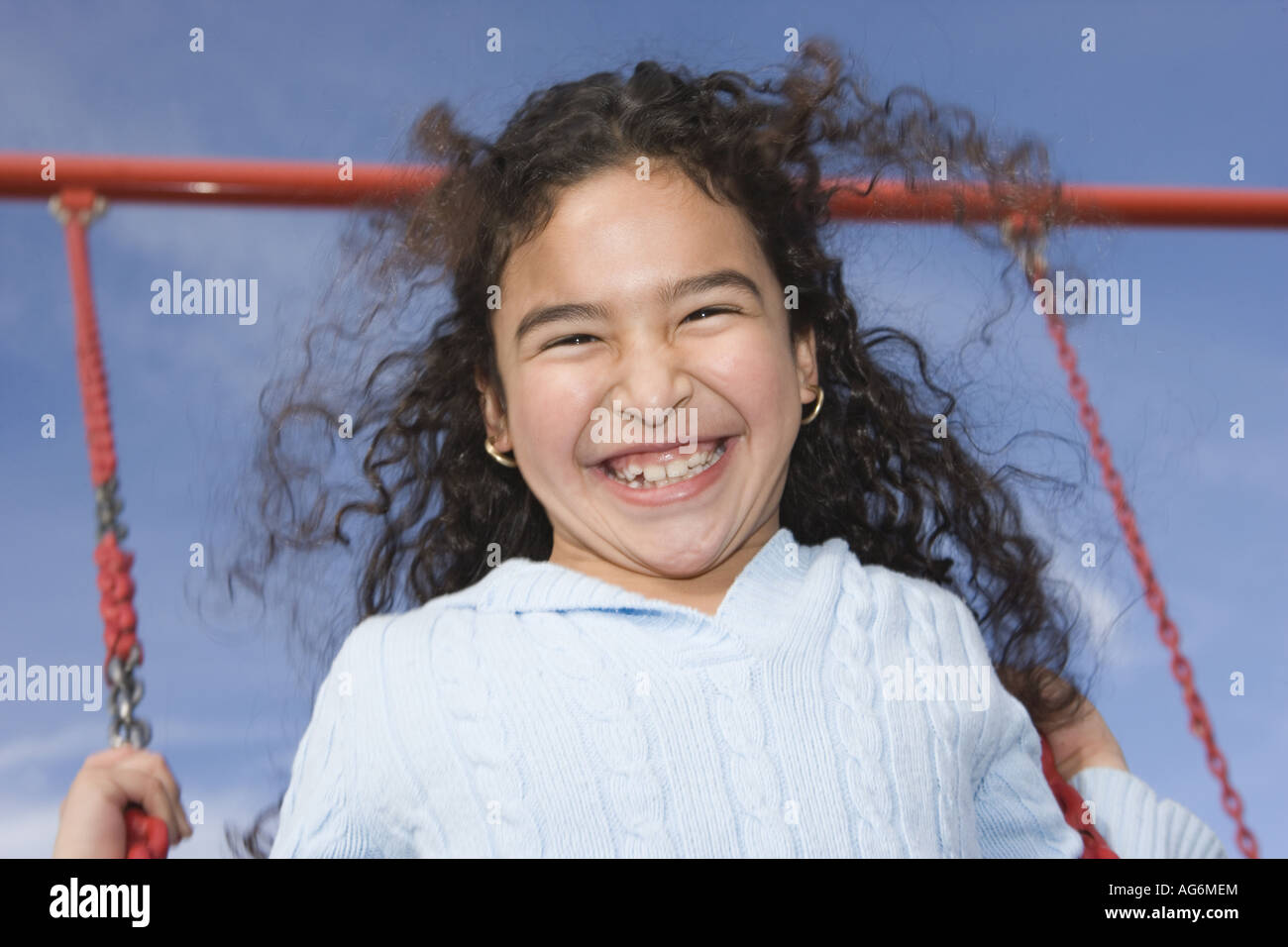 girl making ecstatic face while swinging hight into the air Stock Photo ...