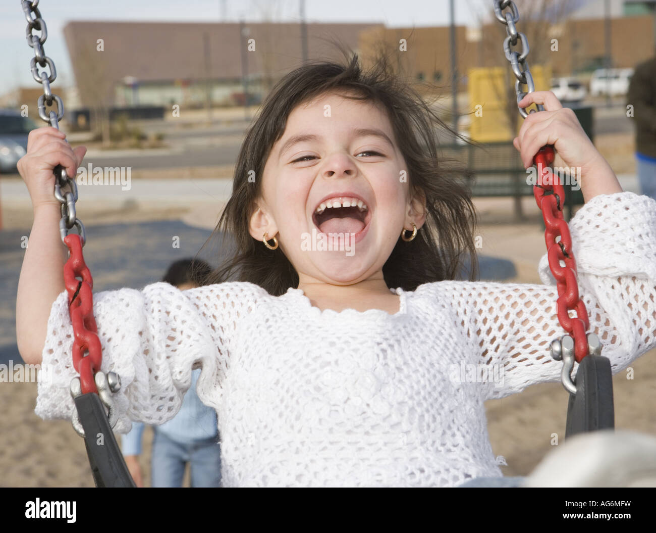 ecstatic five year old girl swinging outdoors smile laugh happy ...