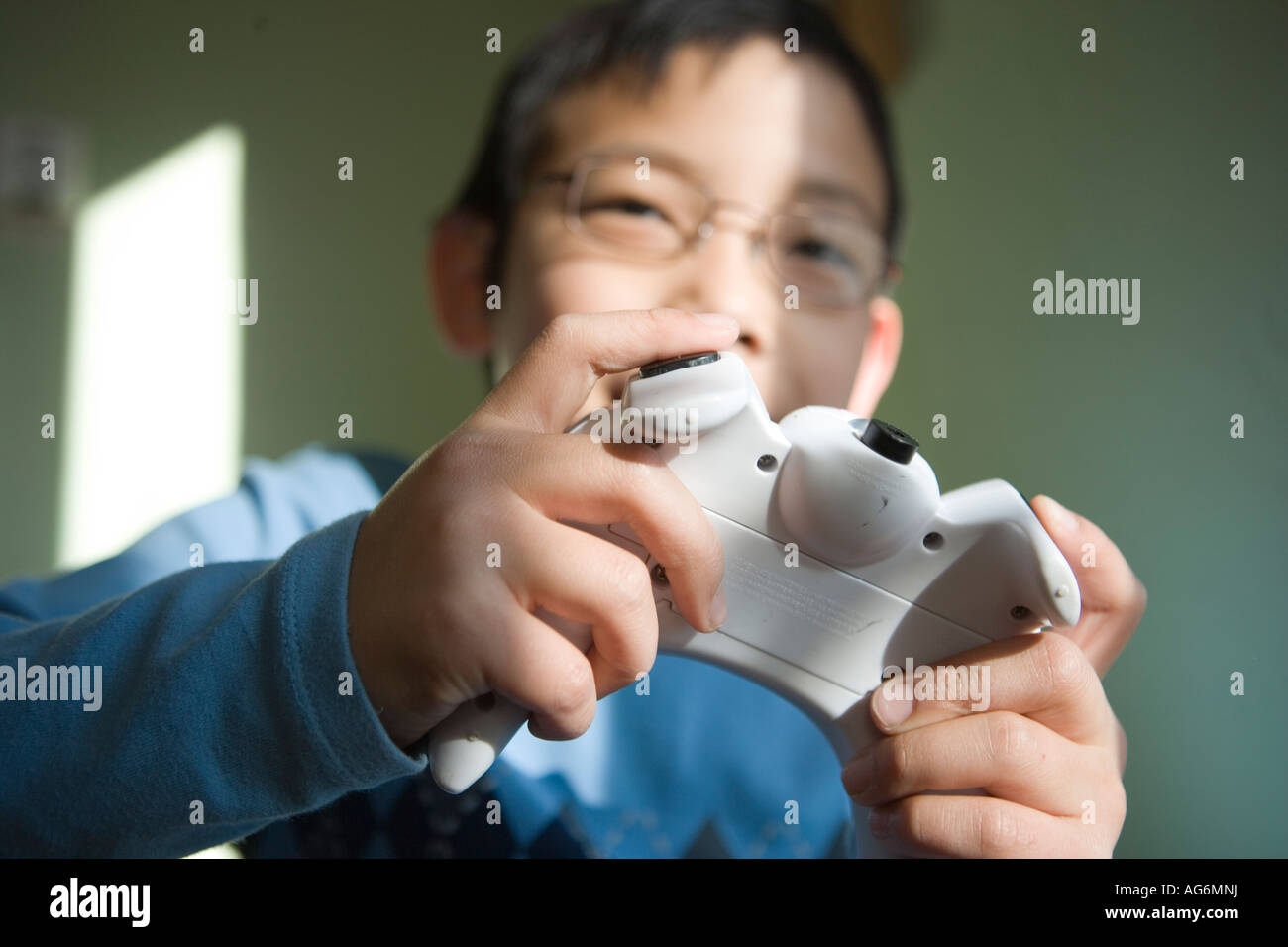 young Japanese boy playing video game closeup Stock Photo - Alamy