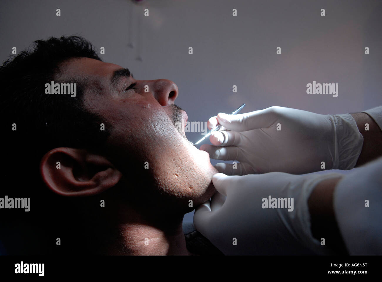 Patient being treated by a dentist at a dental clinic operated by ...