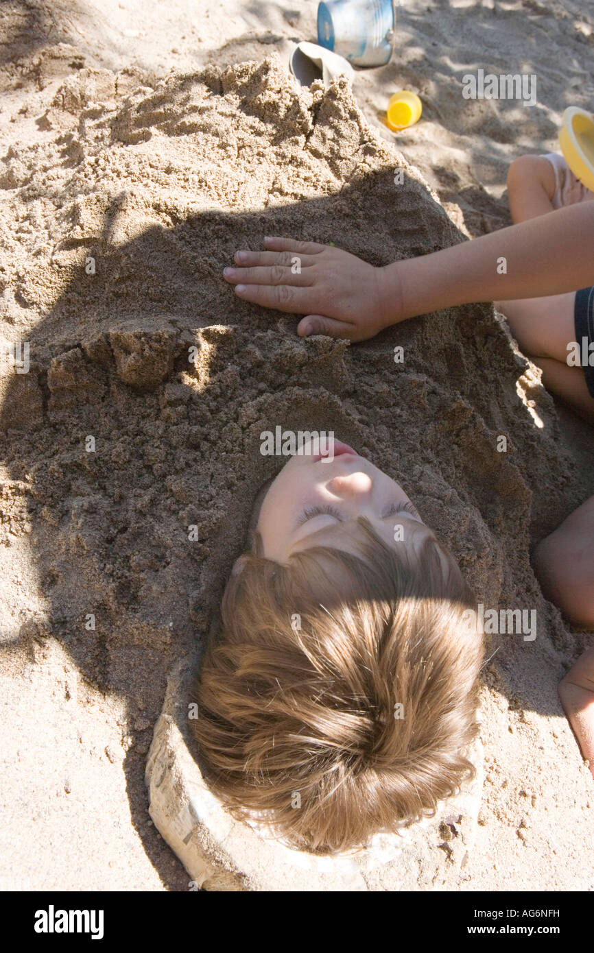 Body buried in sand hi-res stock photography and images - Alamy