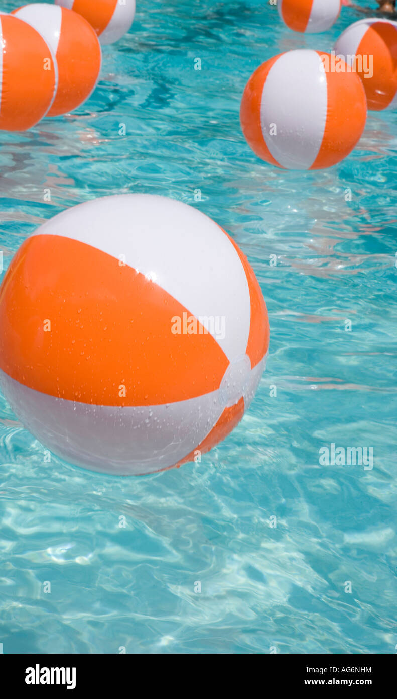 beach balls floating in swimming pool Stock Photo - Alamy
