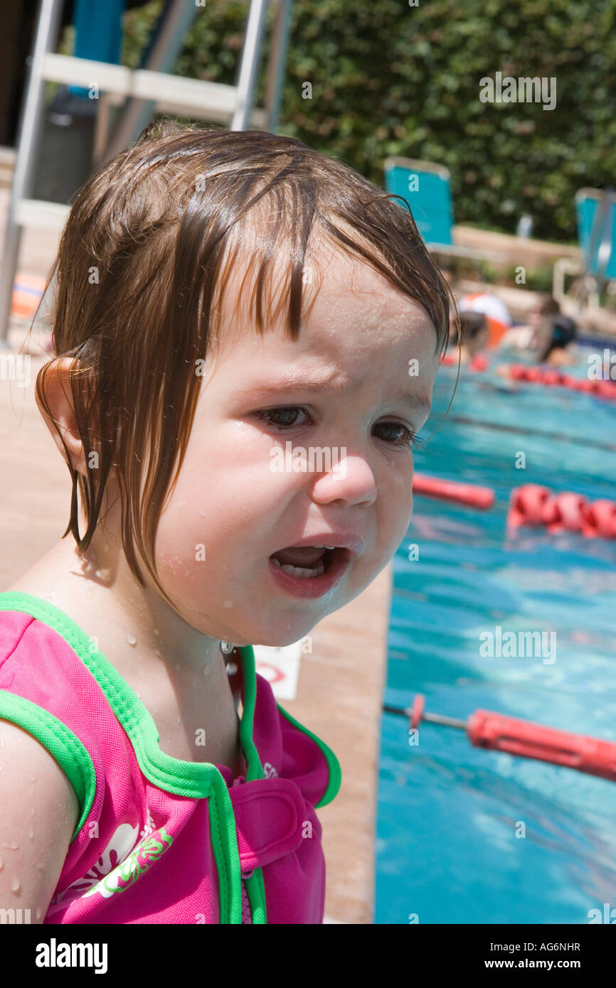 two year old girl crying next to swimming pool Stock Photo - Alamy