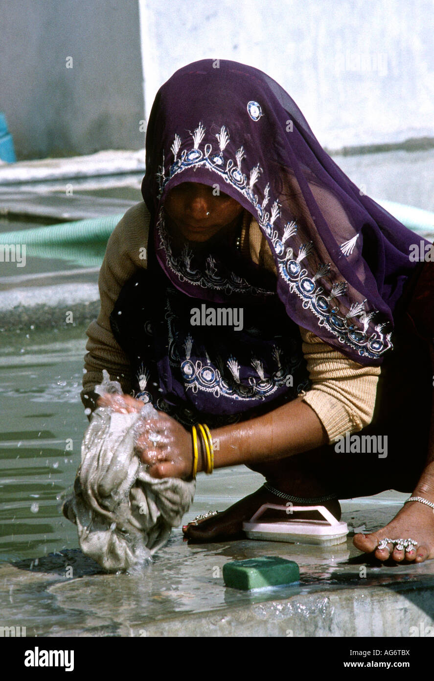 Indian woman washing clothes by hand hi-res stock photography and ...