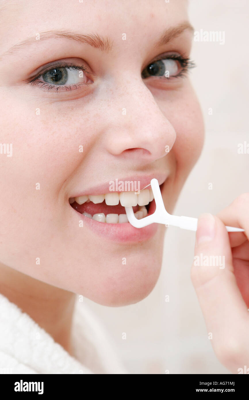A young woman is using interdental floss Stock Photo - Alamy