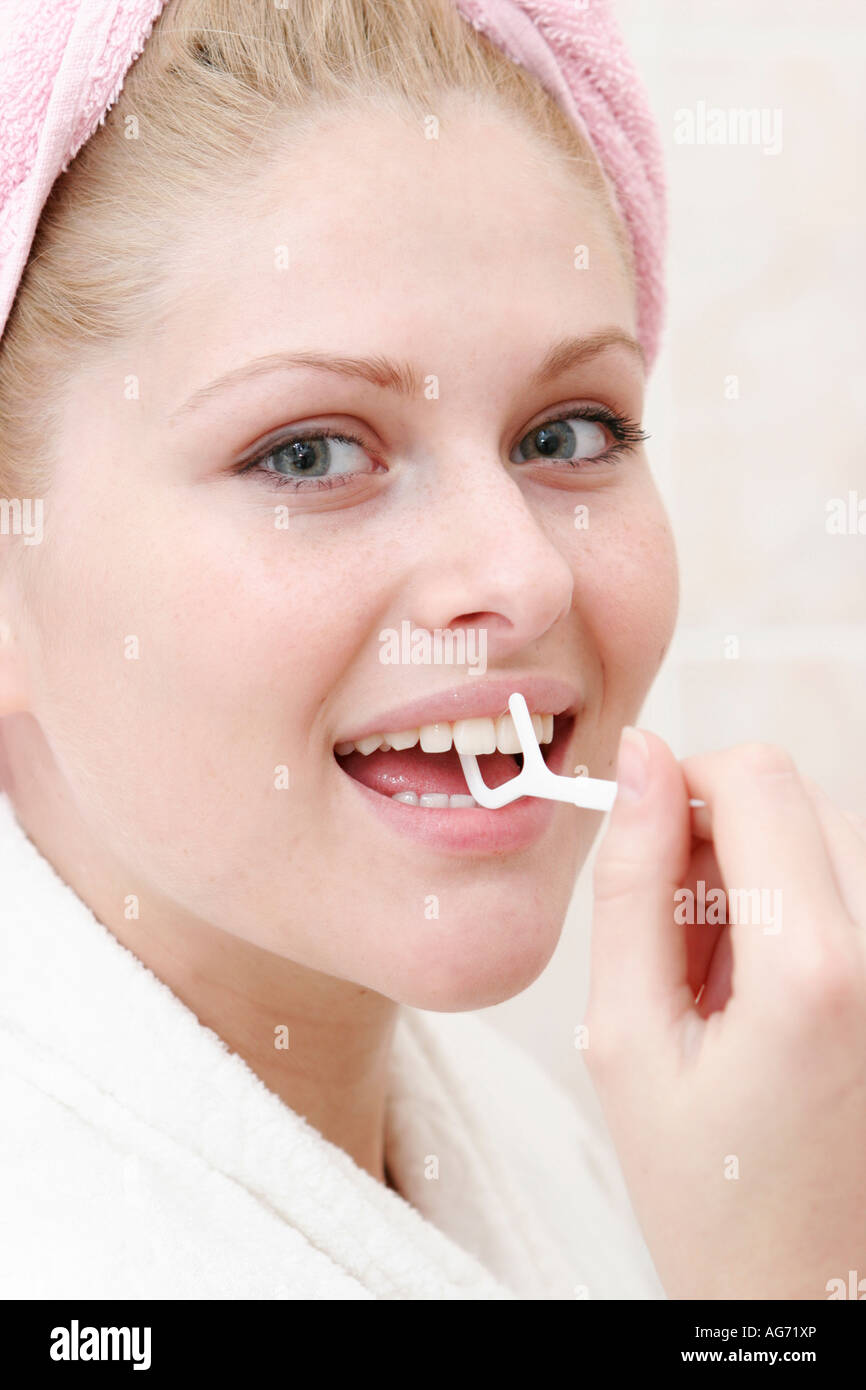 A young woman is using interdental floss Stock Photo - Alamy
