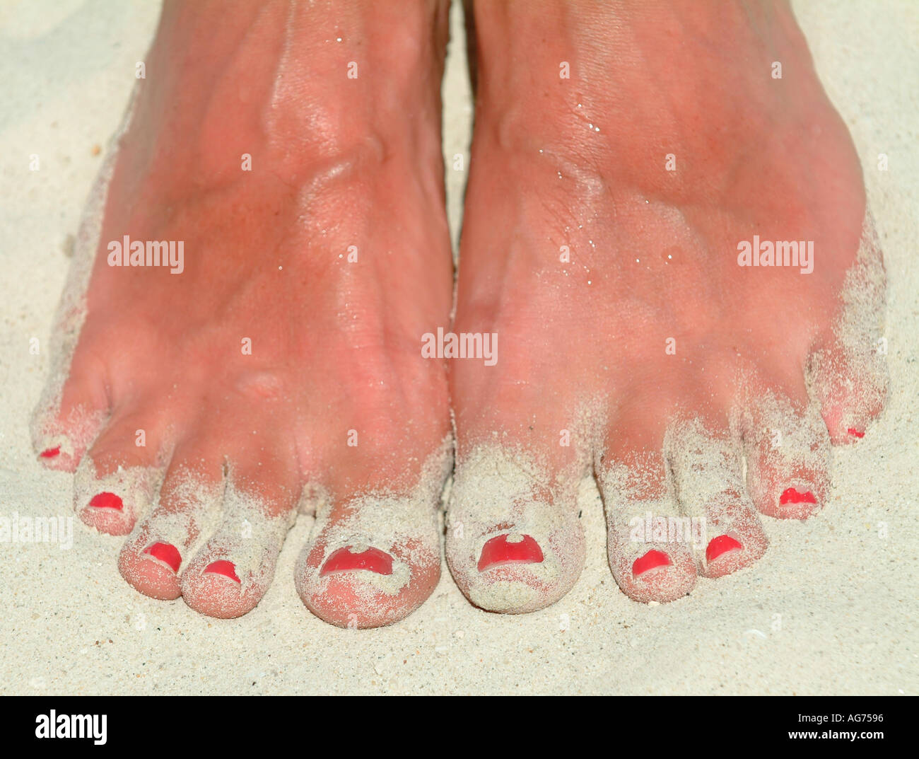 feet red toenails painted sand Stock Photo - Alamy