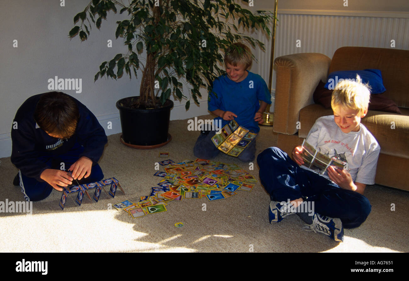 Three boys playing with Pokemon cards Stock Photo - Alamy