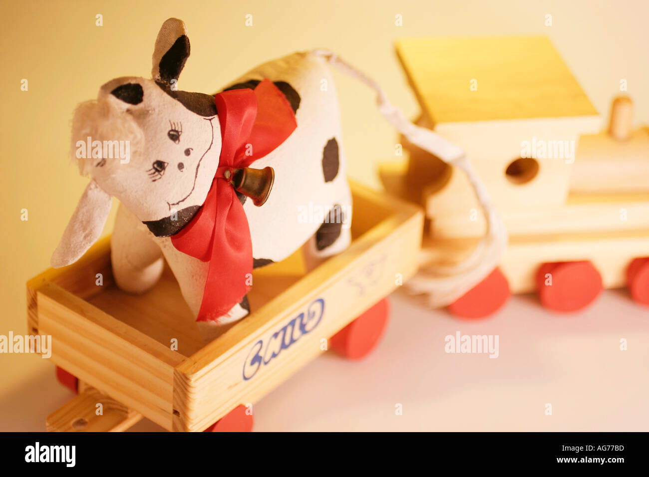 Toy Cow on Wooden Train Stock Photo - Alamy