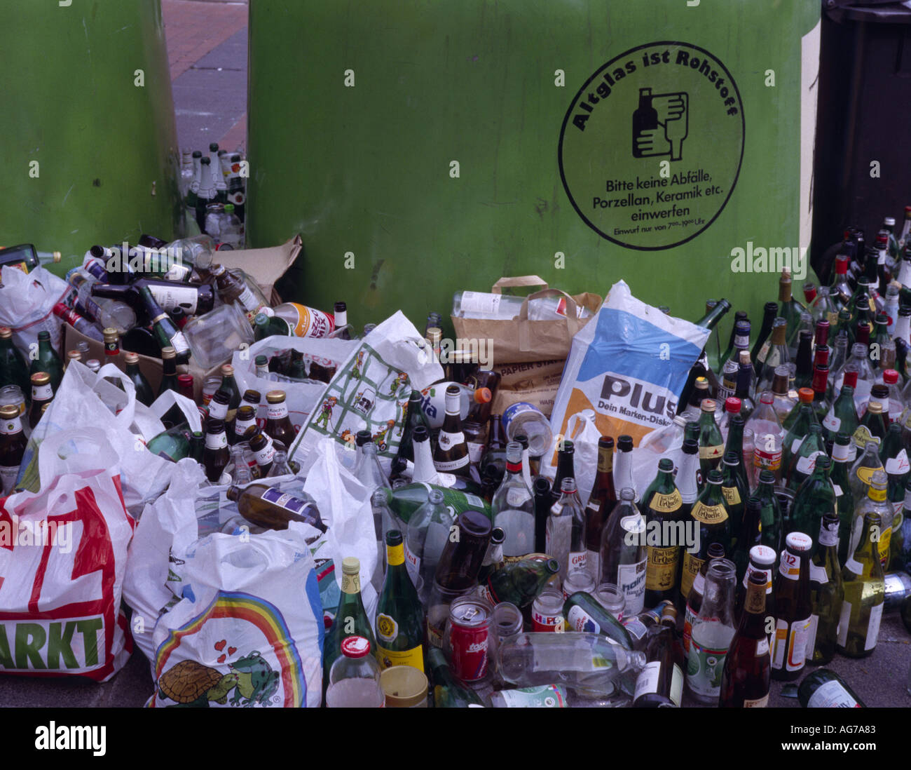 glass waste in front of a full container Stock Photo - Alamy