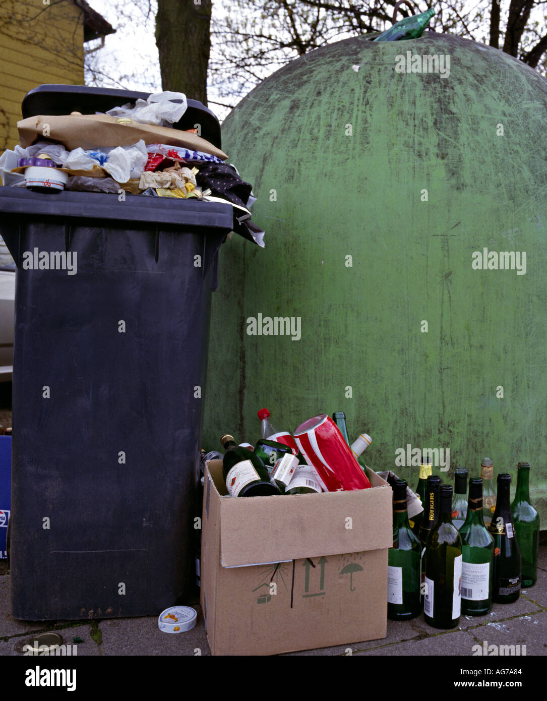 full dust bin and full glass container Stock Photo - Alamy