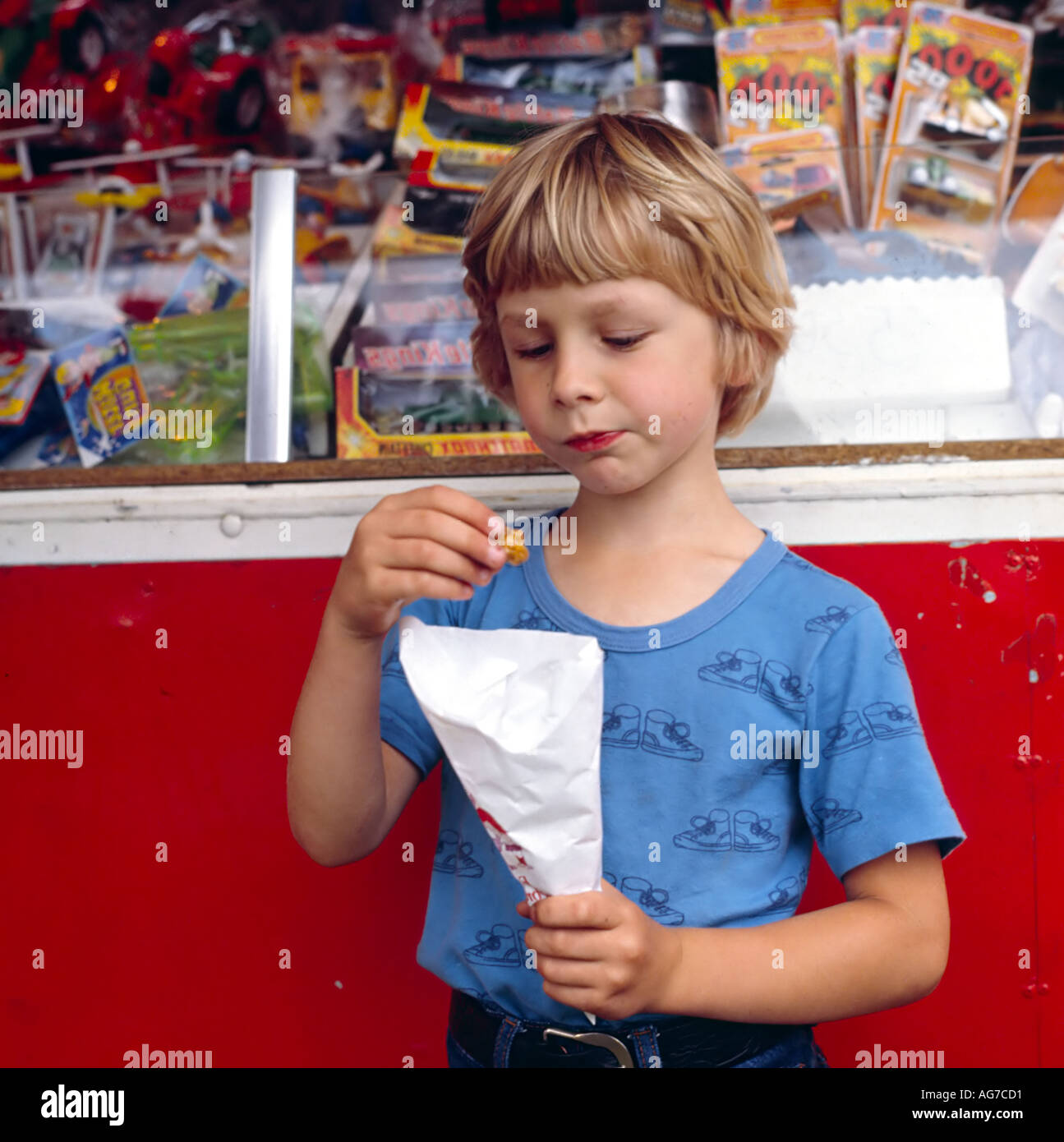 faire haired blonde boy eating roasted almonds Stock Photo - Alamy