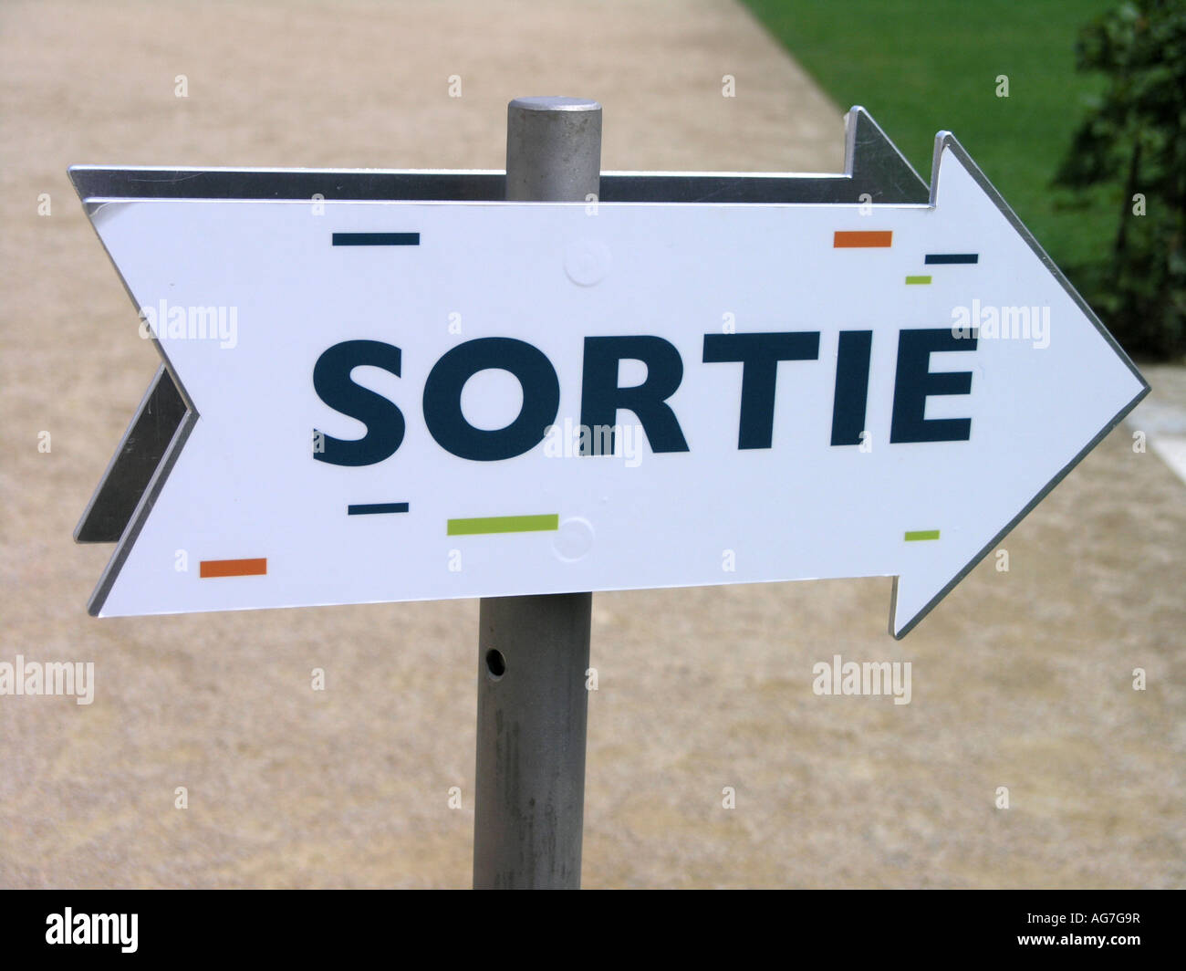 Arrow shaped sign saying Sortie or exit in French Stock Photo - Alamy